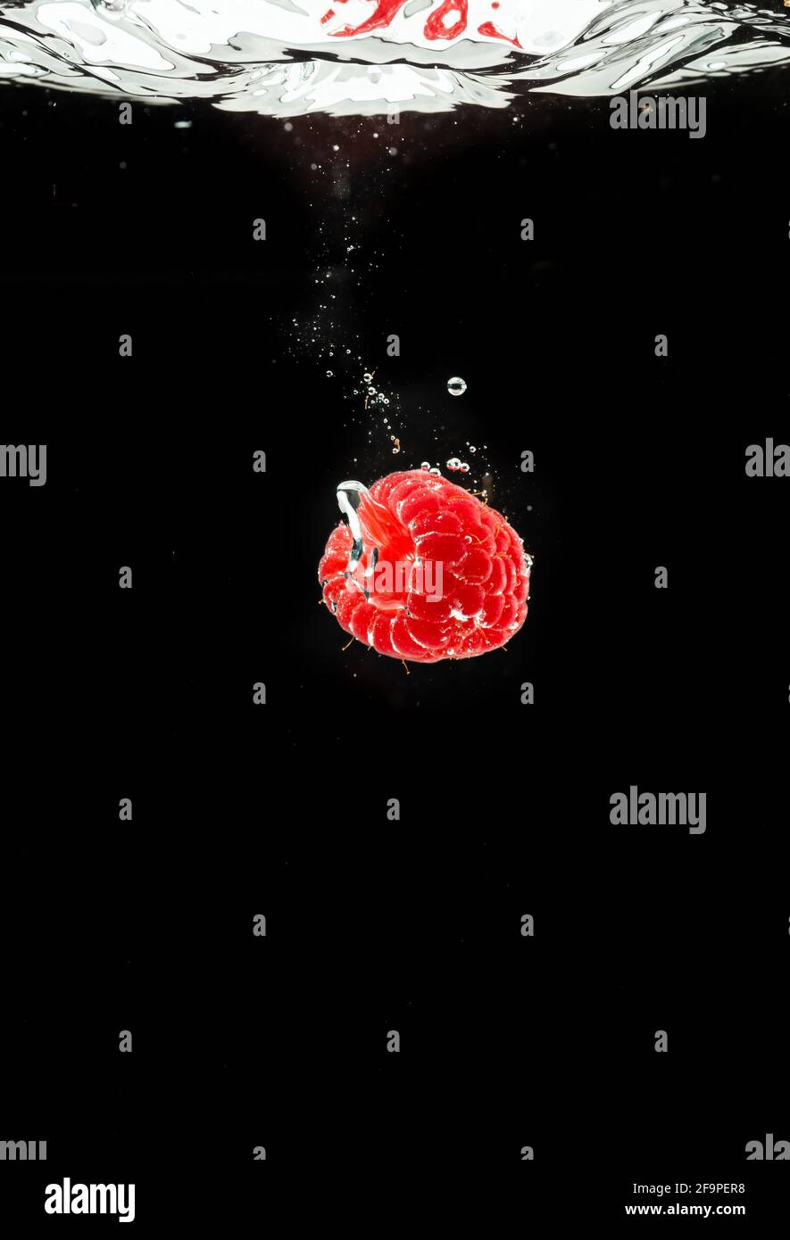 Close up red raspberry falling hi-res stock photography and images - Alamy