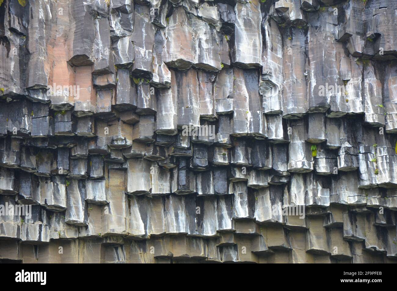 Closeup shot of basalt columns in Svartifoss, a stone background Stock ...