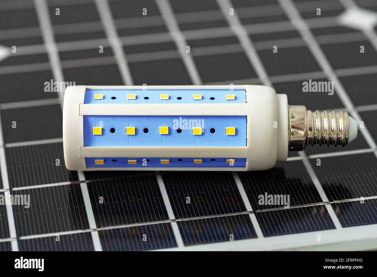 Solar energy panel and light bulb, green energy Stock Photo - Alamy