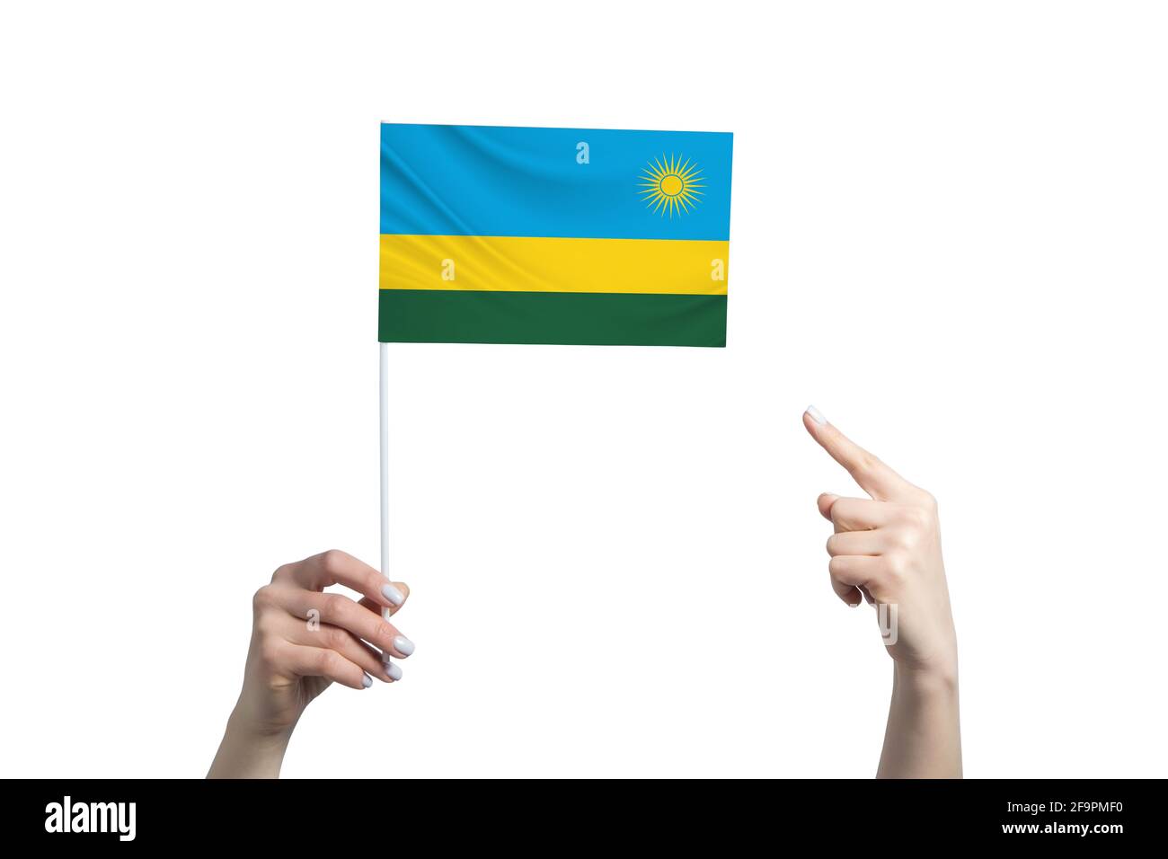 A beautiful female hand holds a Rwanda flag to which she shows the ...