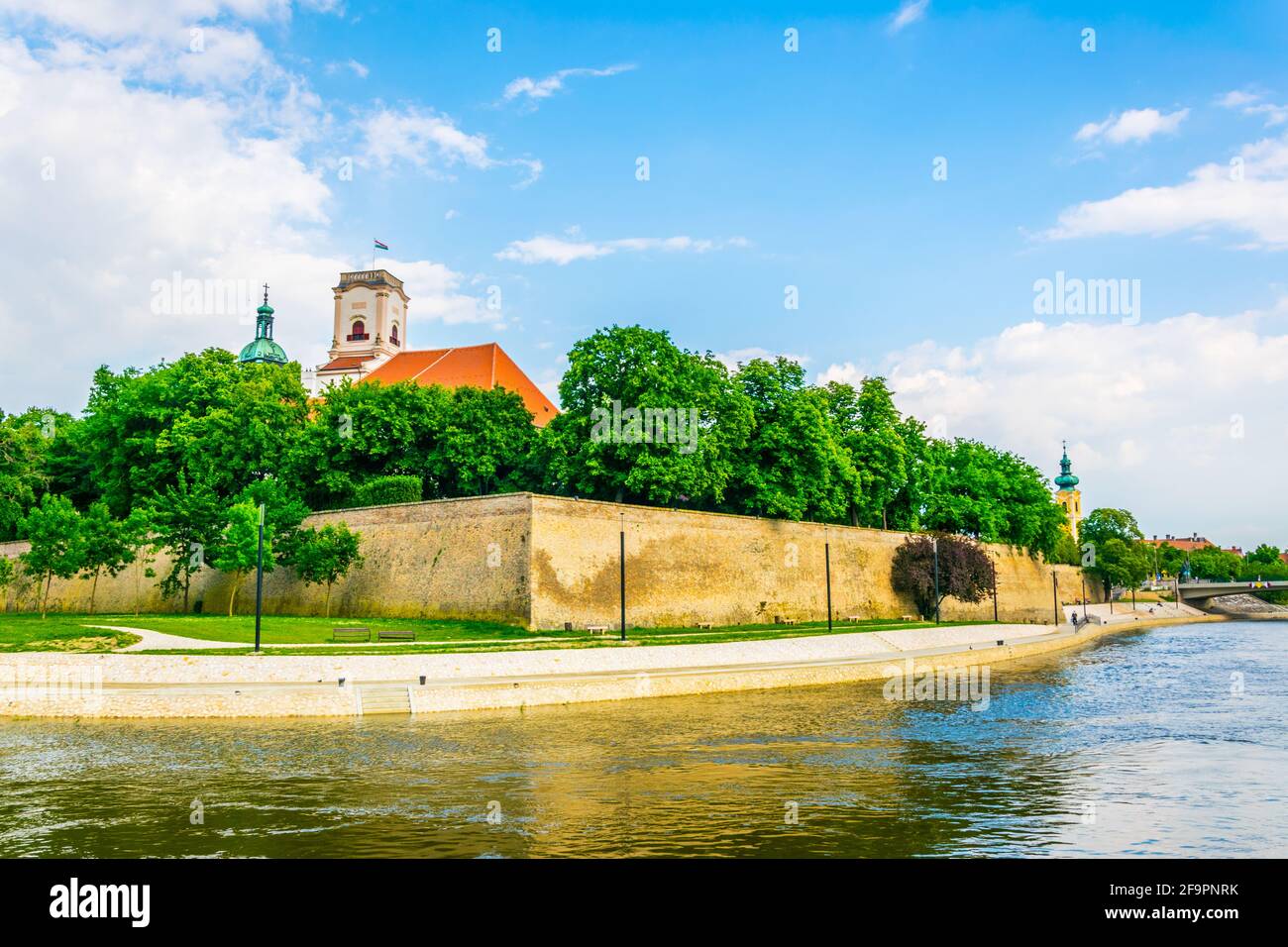 bishop castle and cathedral tower over the river in gyor city in ...