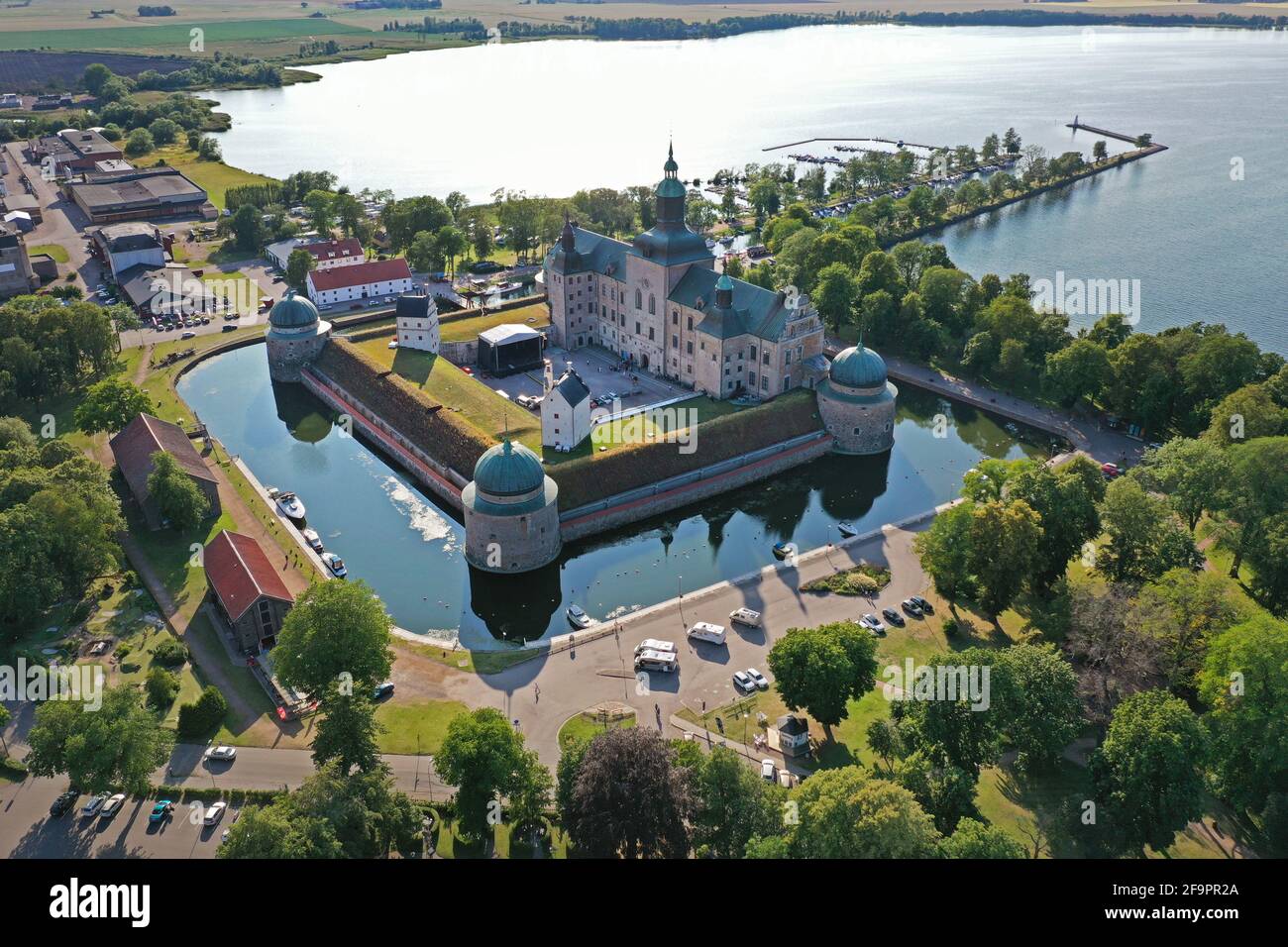 Boats and jet skis in the moat to Vadstena Castle Stock Photo - Alamy