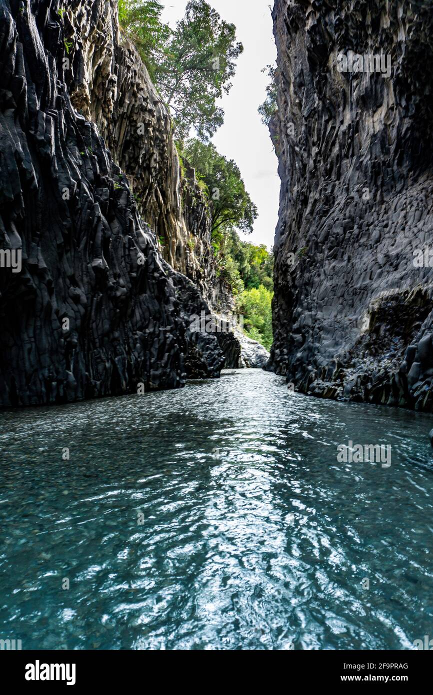 Alcantara river gorge flowing among basalt geological formations in ...