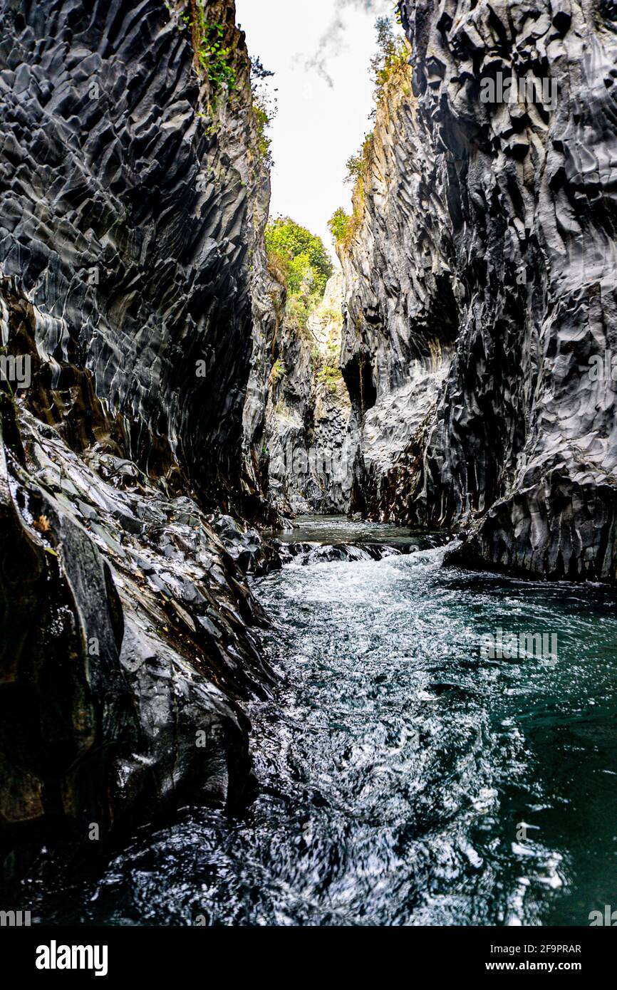 Alcantara river gorge flowing among basalt geological formations in ...