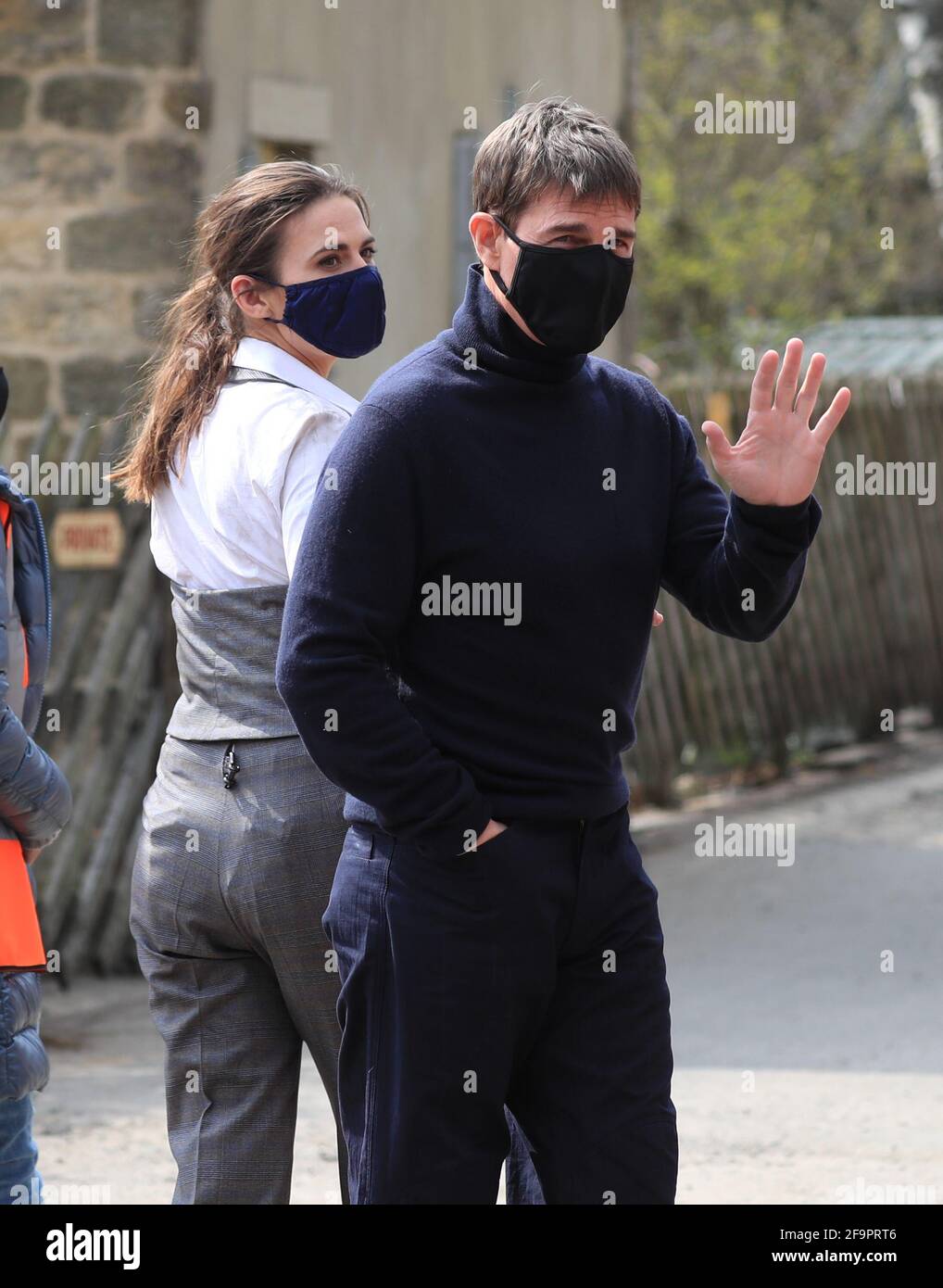 Actor Tom Cruise waves to onlookers as he walks to the set of his ...