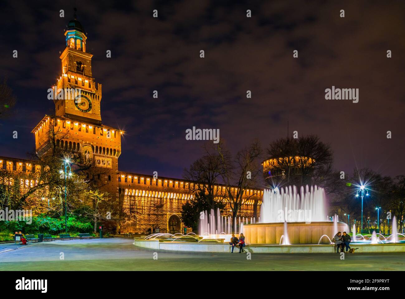 night view of an illuminated fountain in front of the castello ...