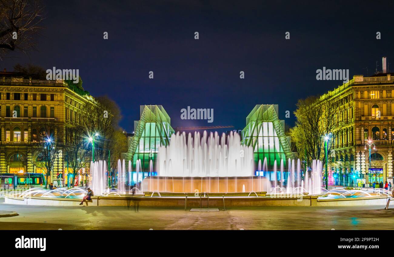 night view of an illuminated fountain in front of the castello ...