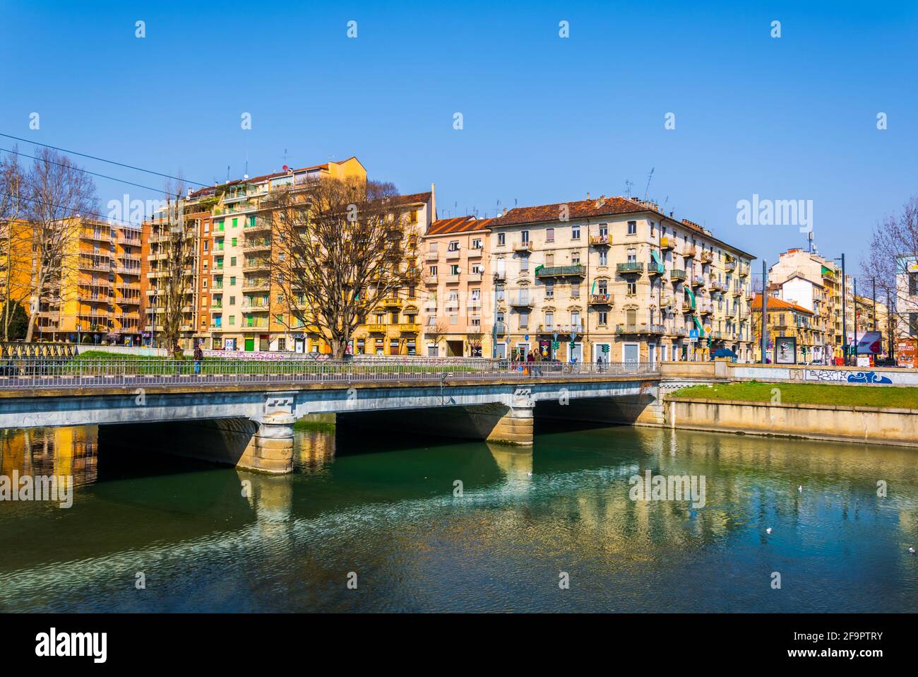 historical buildings stretched along riverside of dora riparia river in ...