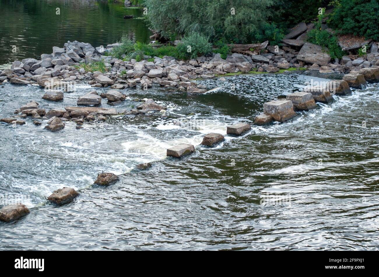 stones in the river near the dam. photo Stock Photo - Alamy