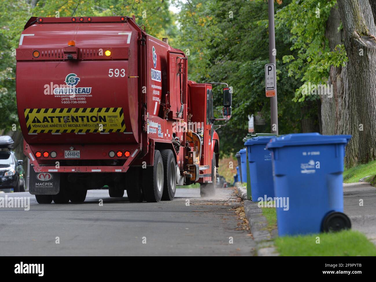 Recycling truck on a street with recycling bins Stock Photo - Alamy
