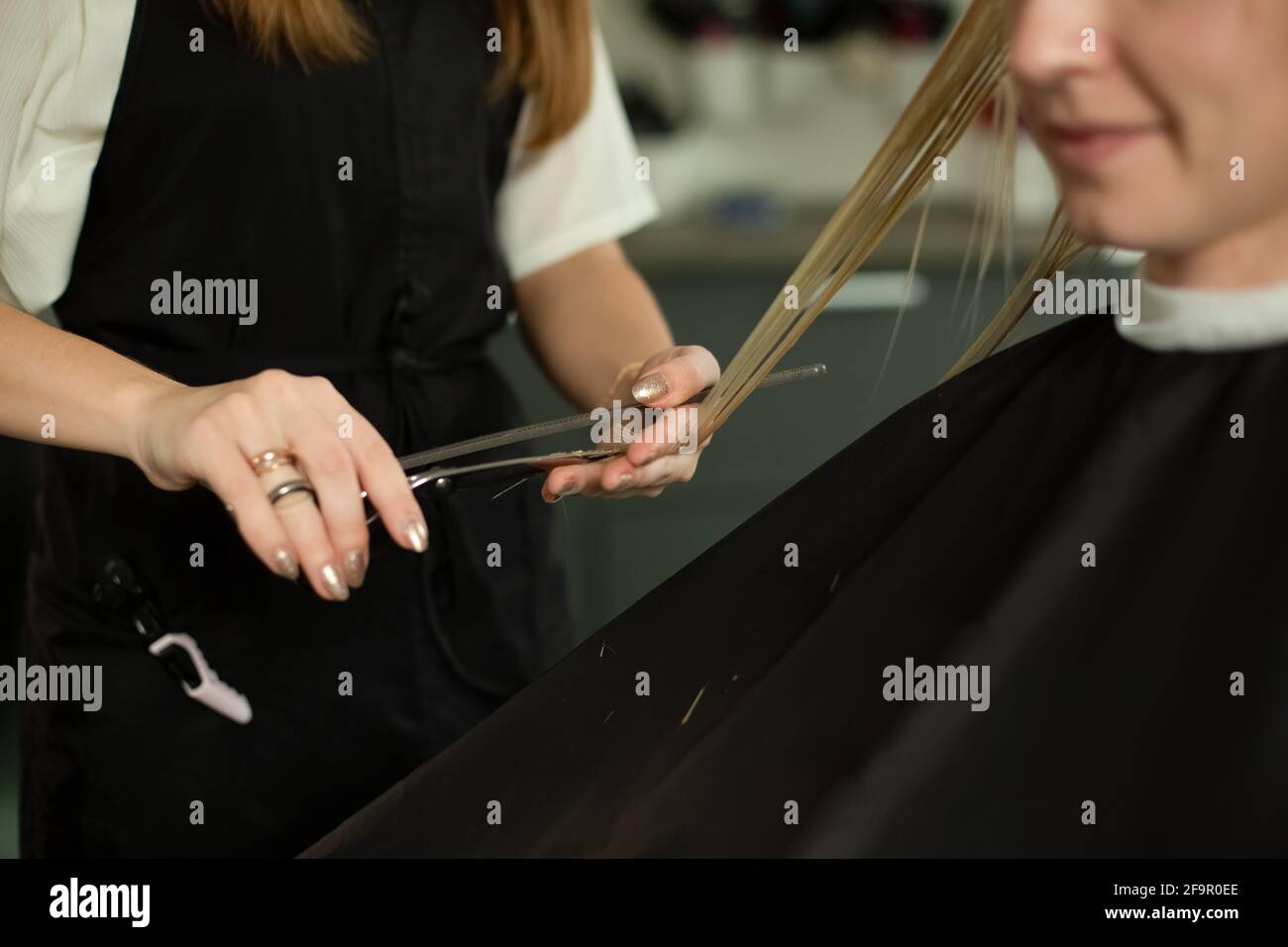 Blonde girl with long hair sits in a chair in a beauty salon Stock ...