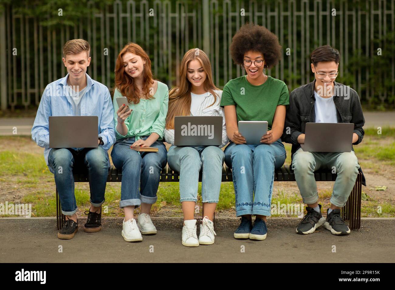 Diverse teens on devices hi-res stock photography and images - Alamy