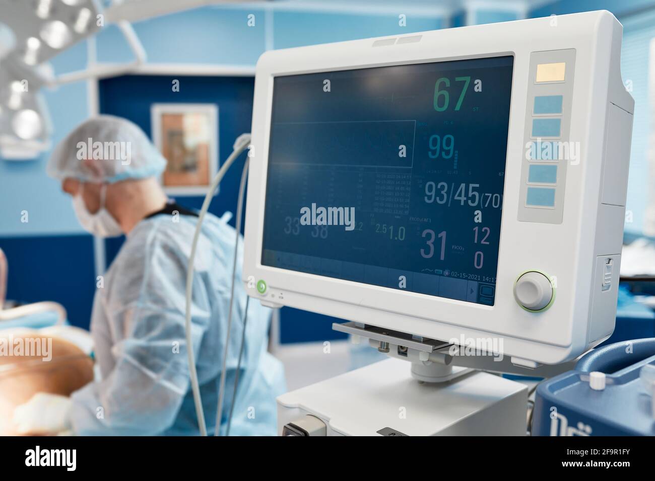 Anesthesiologist keeping track of vital functions of the body during ...