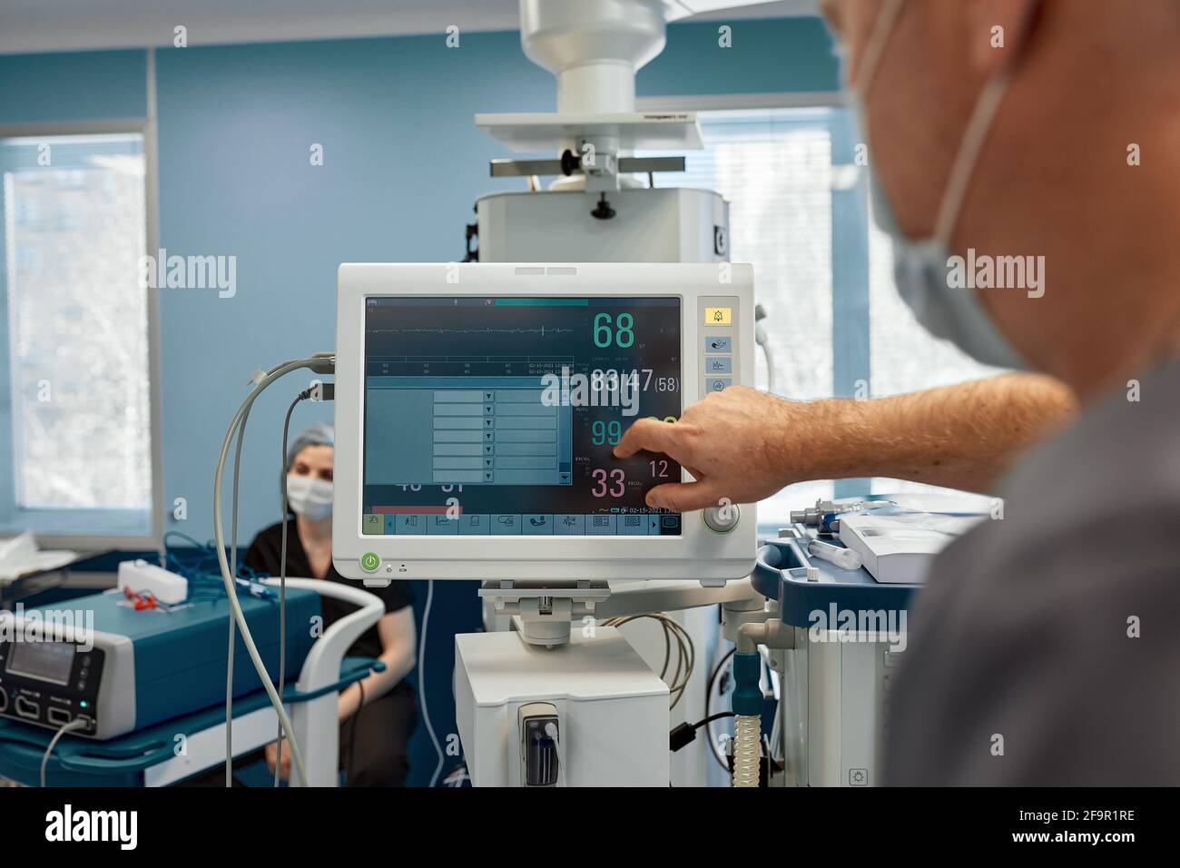 Anesthesiologist keeping track of vital functions of the body during ...