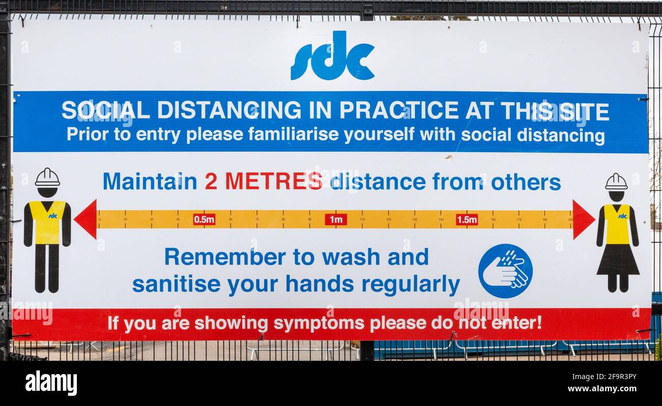 Covid-19 safety measures sign at the entrance to a building site ...