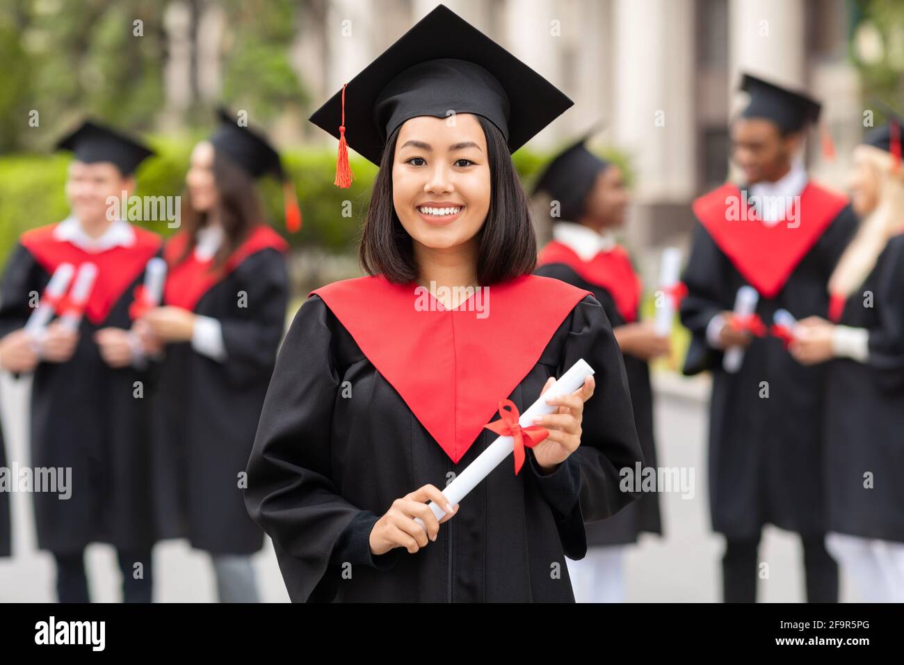 Happy asian woman student cheerfully posing while graduation ceremony ...