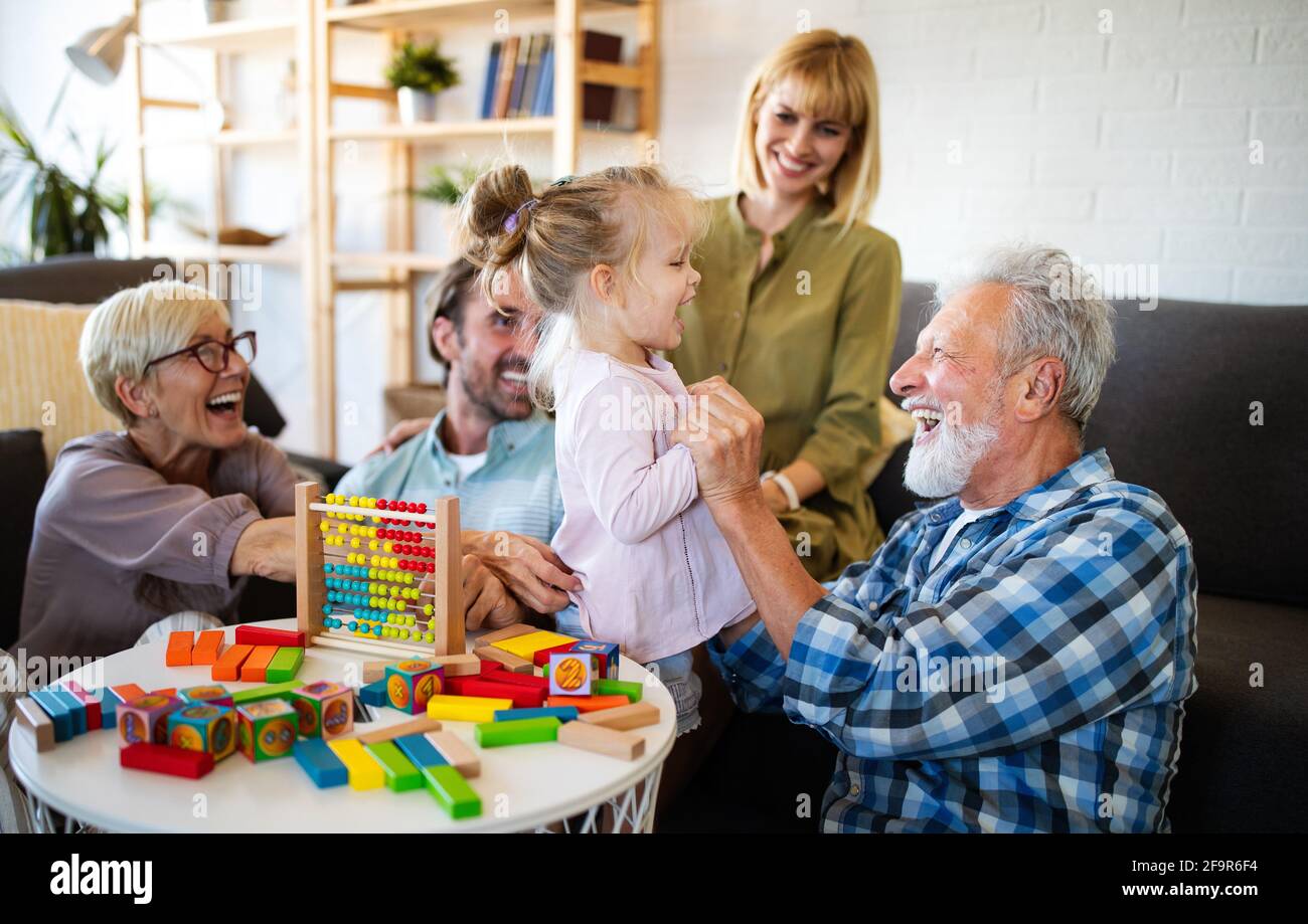 Senior grandparents playing with grandchildren and having fun with ...
