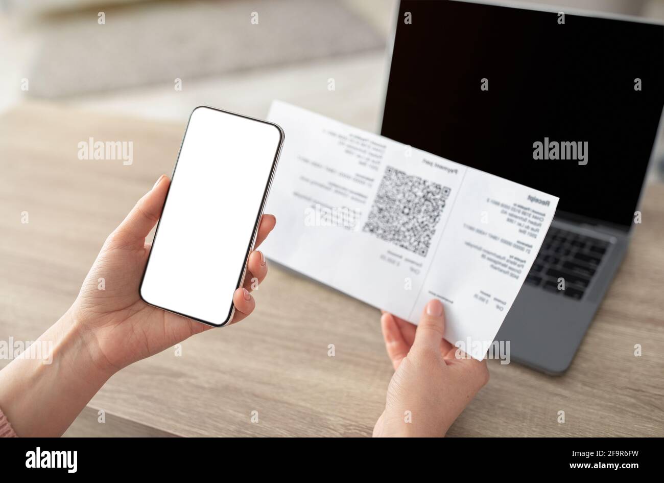 Female hands holding smartphone and scanning the QR code from paper ...