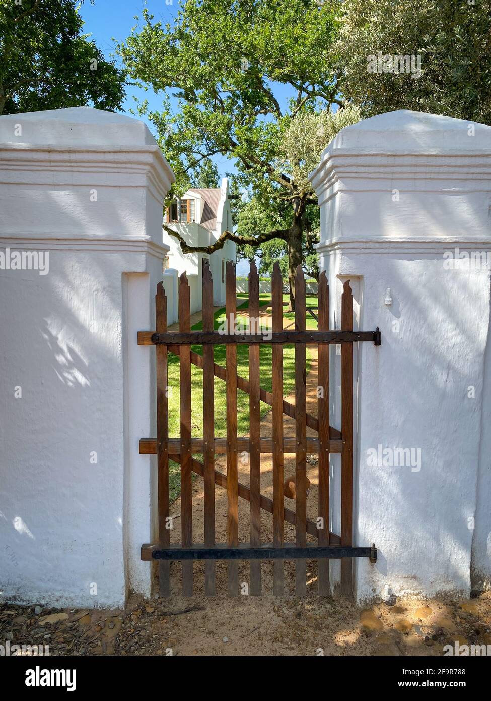 Historical building in cape dutch architecture style behind wooden ...