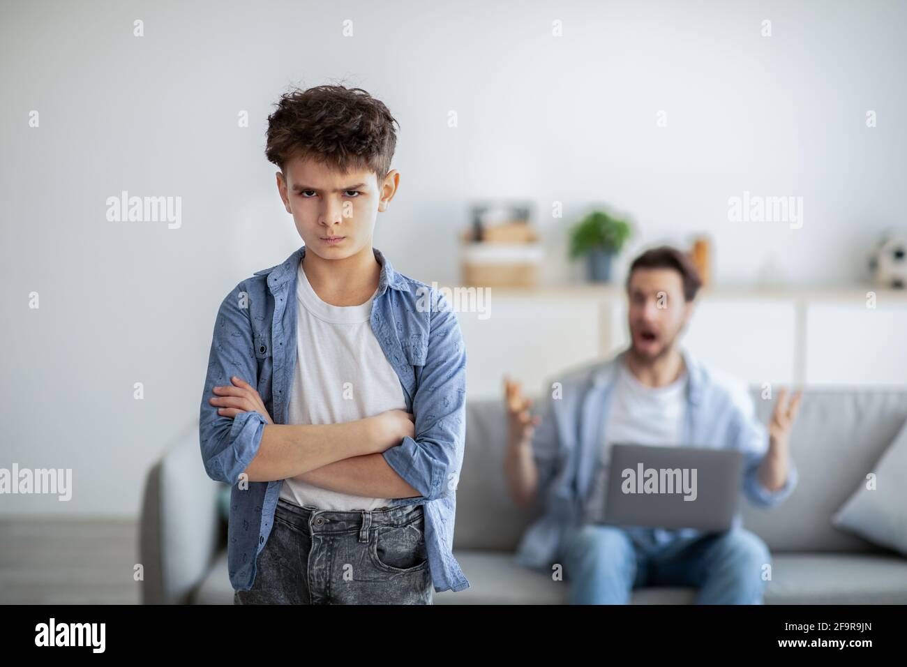 Family problems during quarantine. Angry father shouting at son while ...