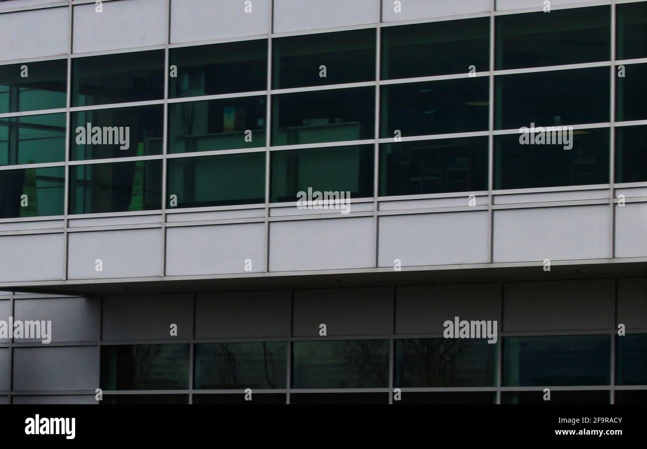 a large multi level parking garage with glass windows Stock Photo - Alamy