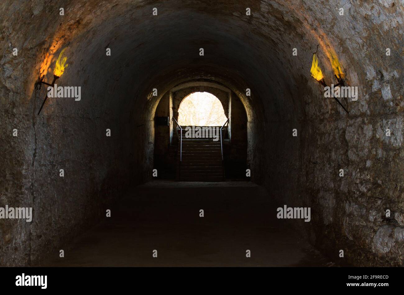 catacombs of the old castle illuminated burning torches Stock Photo - Alamy