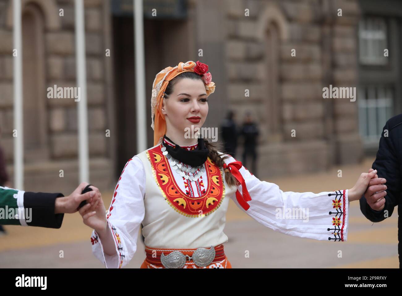 People in traditional folk costumes perform the Bulgarian folk dance ...