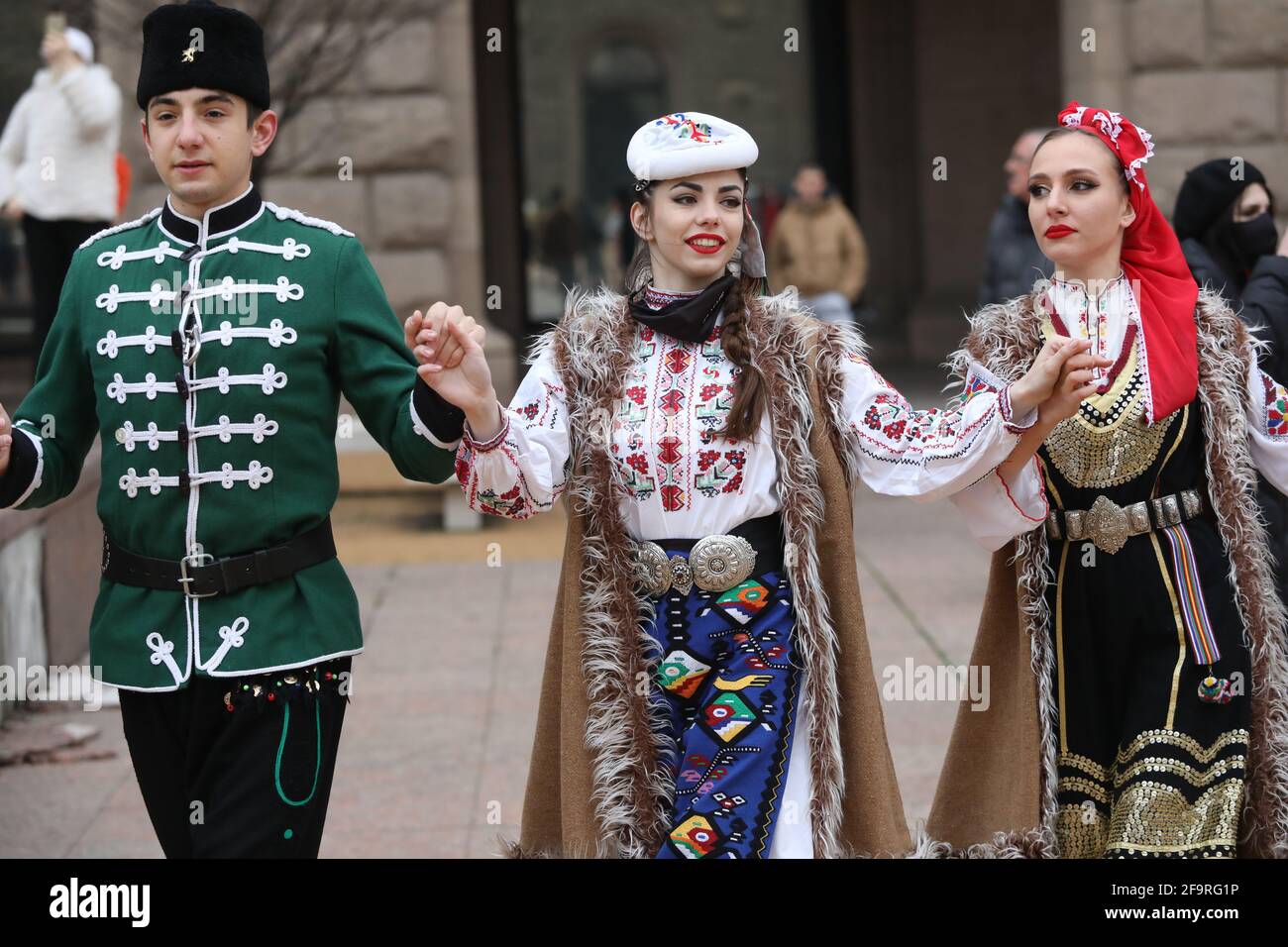 People in traditional folk costumes perform the Bulgarian folk dance ...