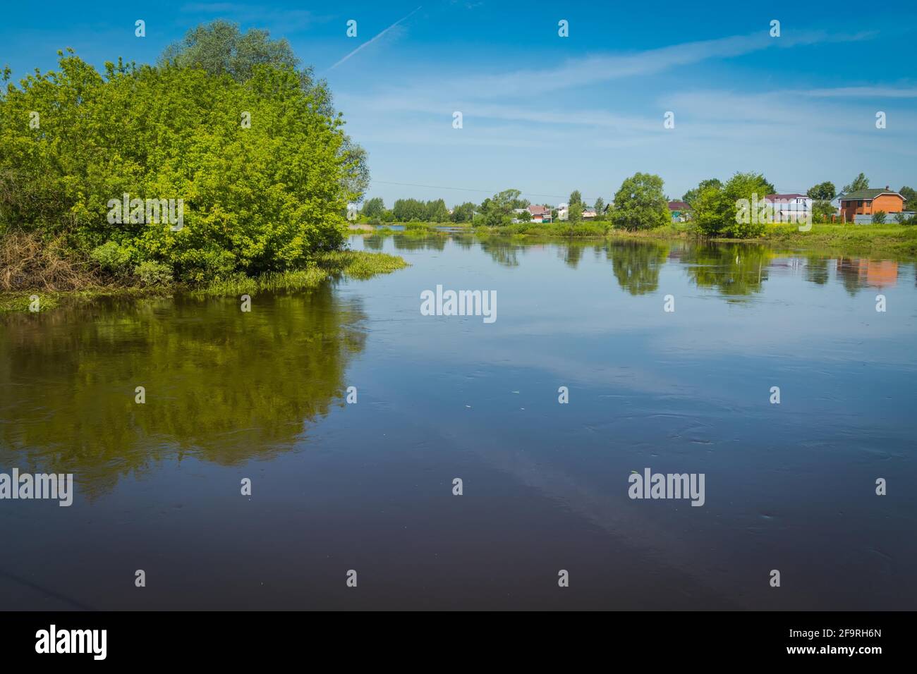Summer rural landscape with river and blue sky background Stock Photo ...