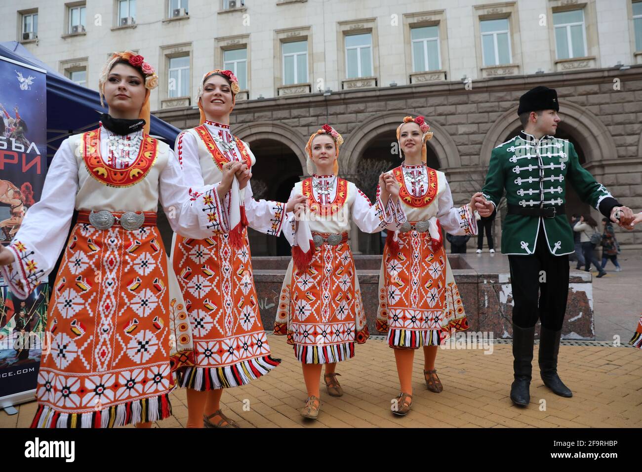 People in traditional folk costumes perform the Bulgarian folk dance ...