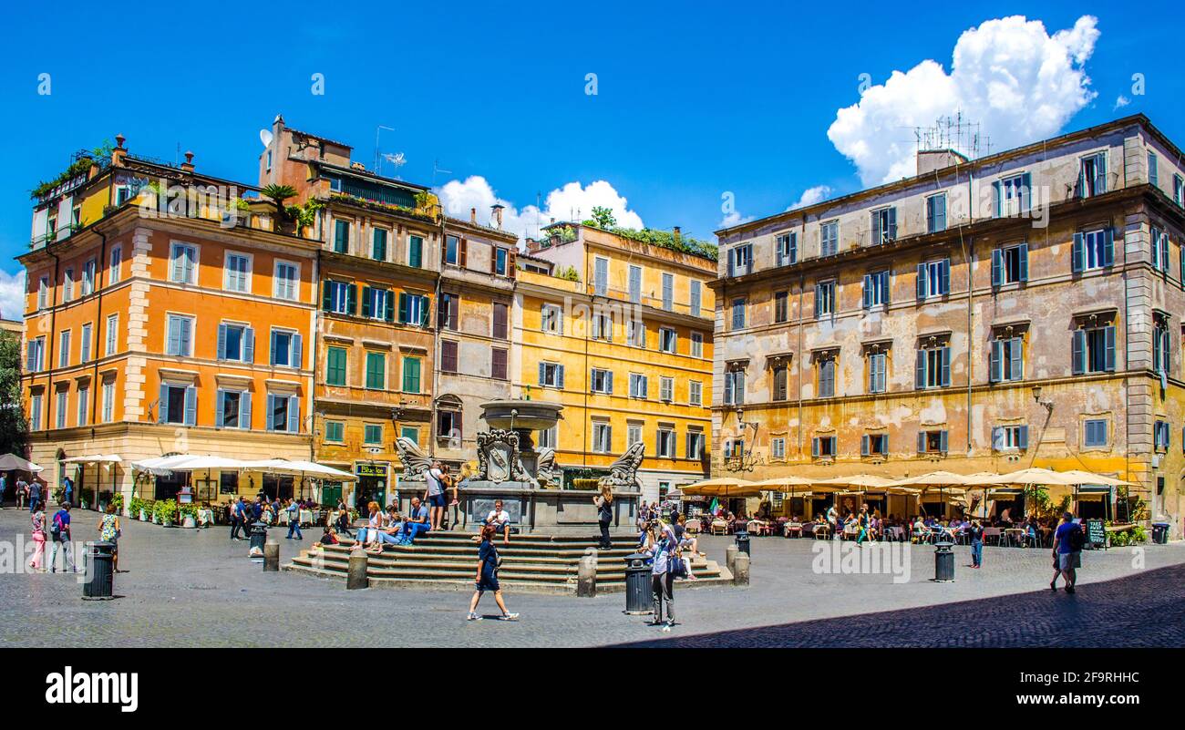 people are strolling through piazza di santa maria situated in front of ...