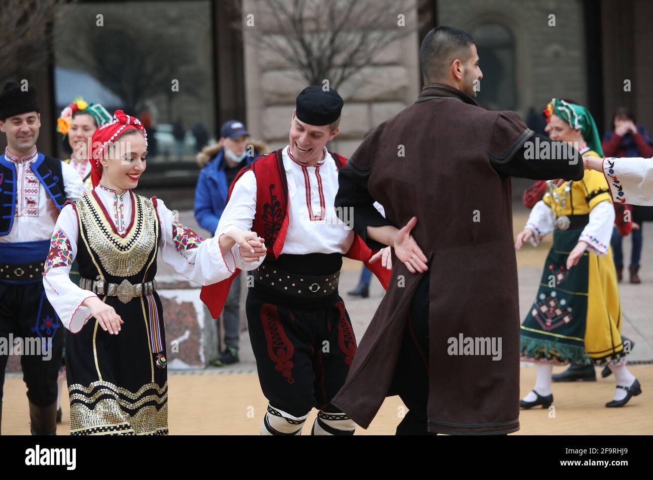 People in traditional folk costumes perform the Bulgarian folk dance ...