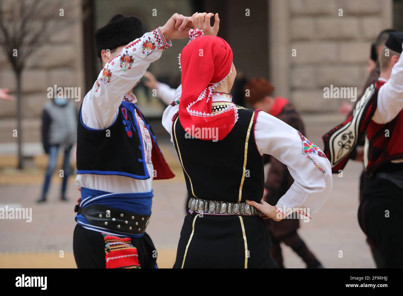 People in traditional folk costumes perform the Bulgarian folk dance ...