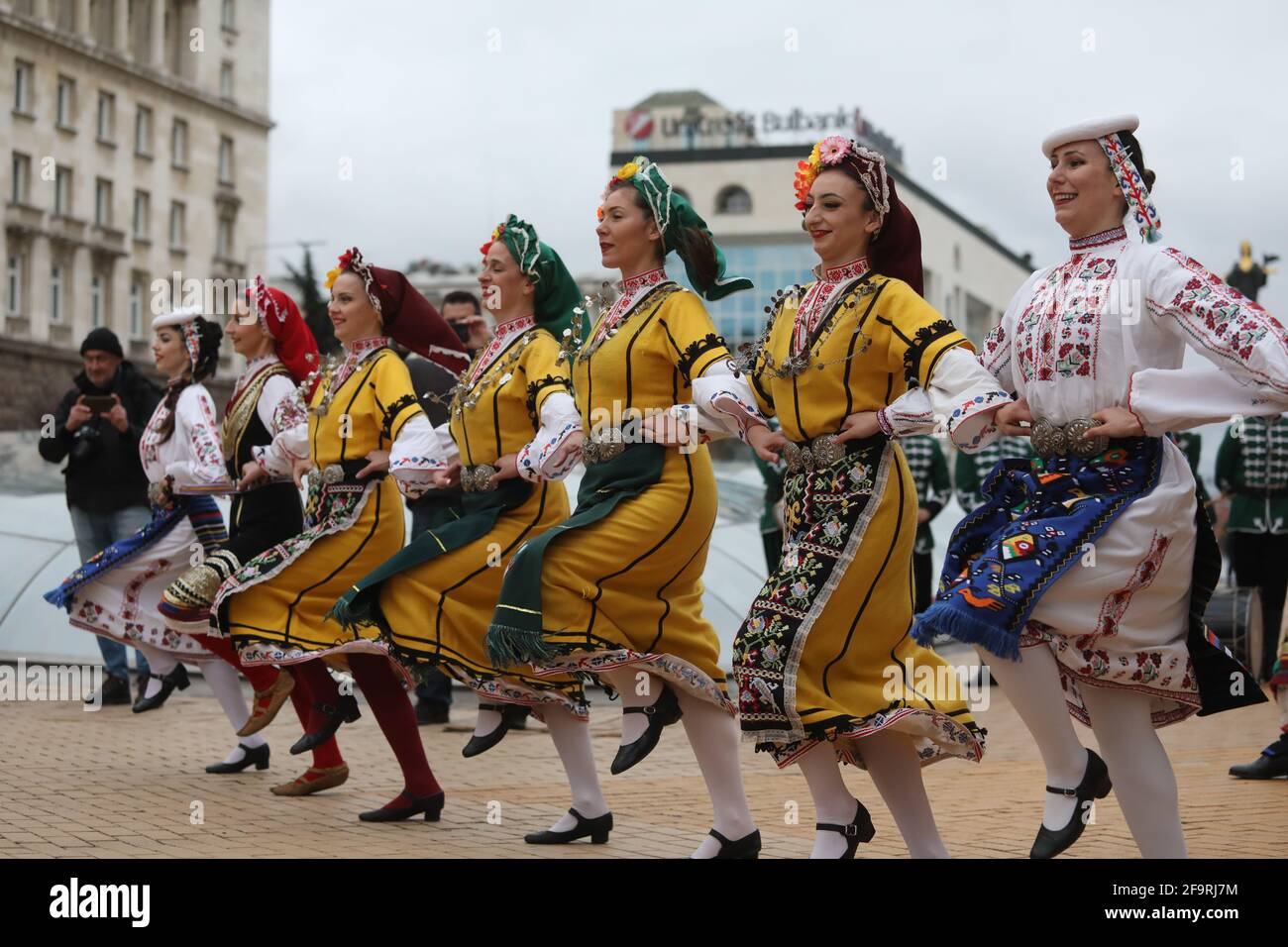 People in traditional folk costumes perform the Bulgarian folk dance ...