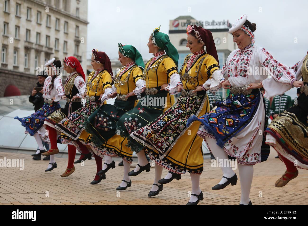 People in traditional folk costumes perform the Bulgarian folk dance ...
