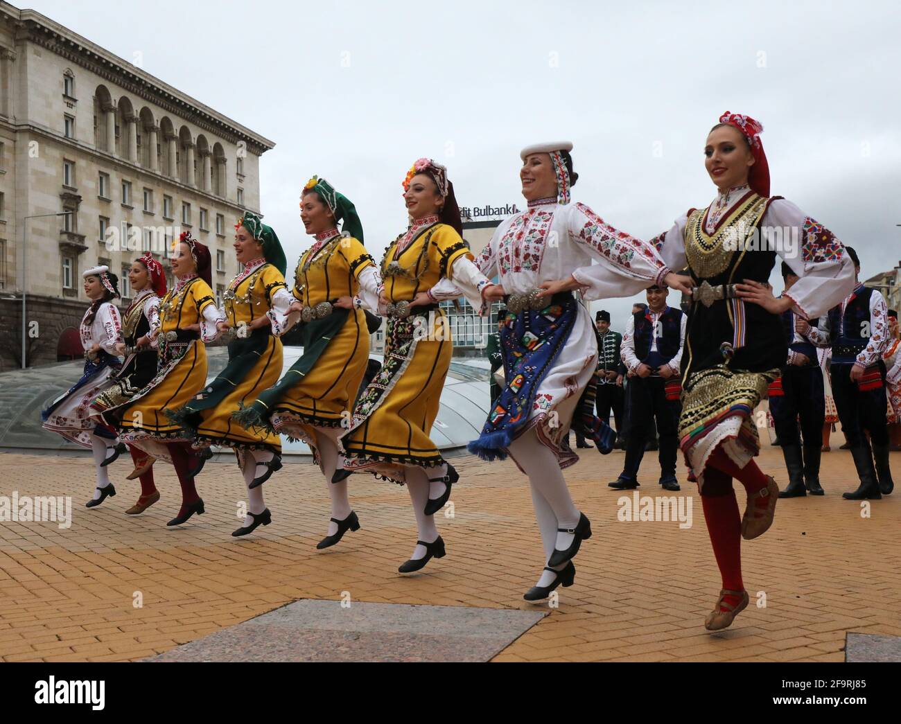 People in traditional folk costumes perform the Bulgarian folk dance ...