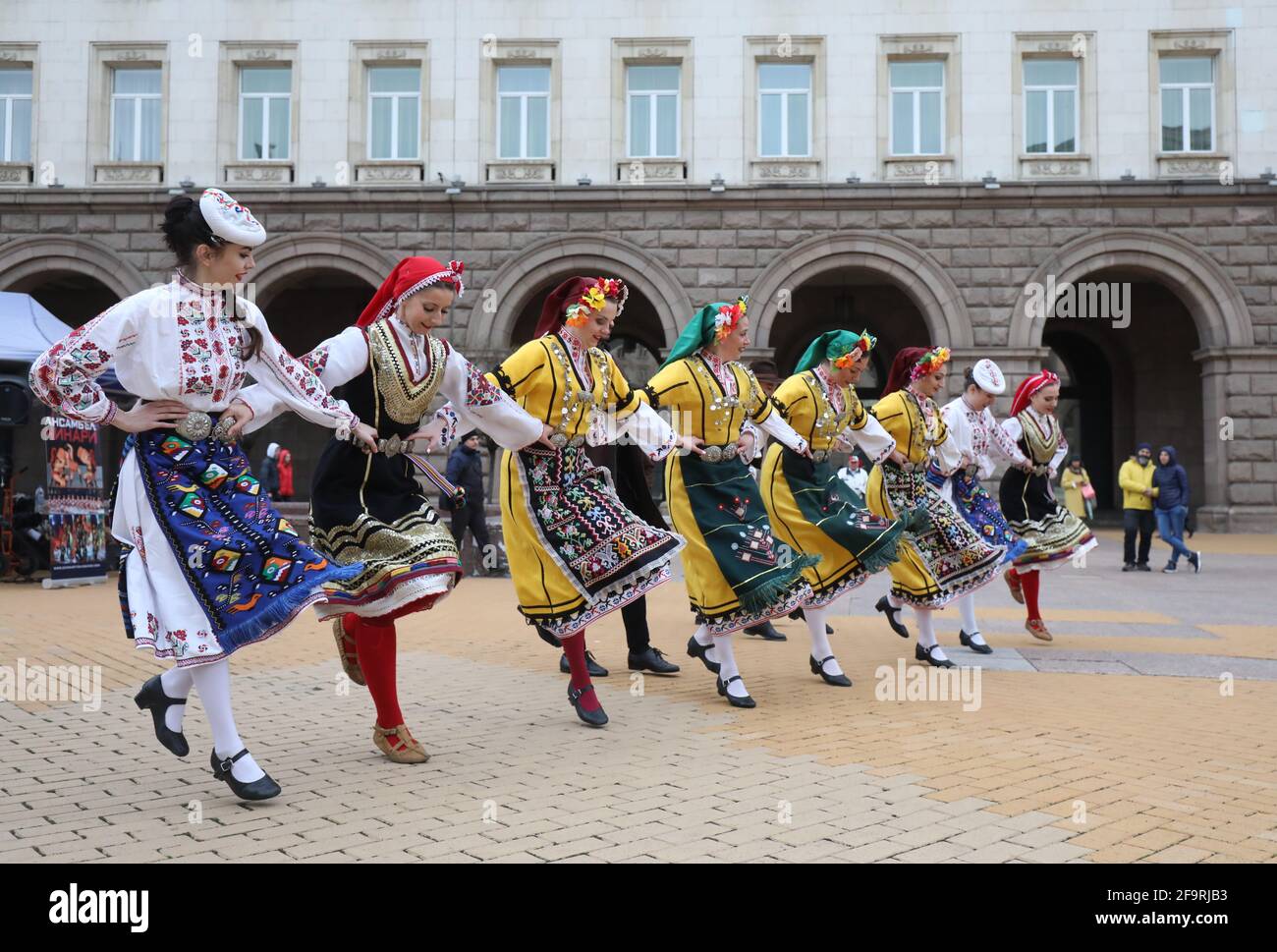 People in traditional folk costumes perform the Bulgarian folk dance ...