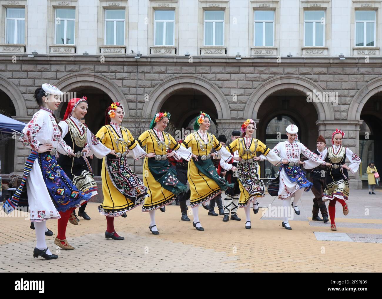 People in traditional folk costumes perform the Bulgarian folk dance ...