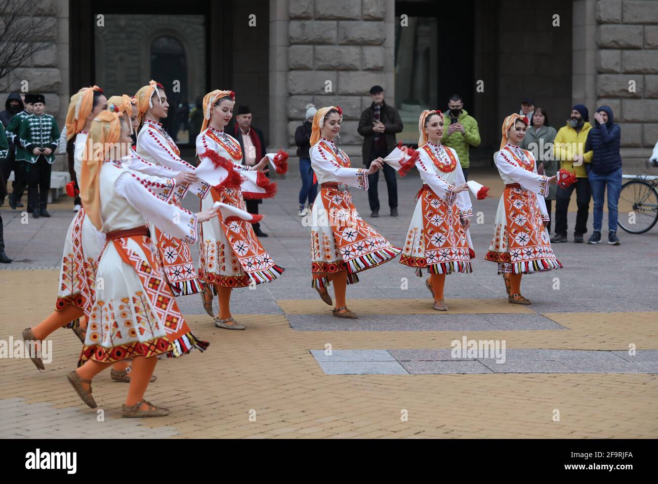 People in traditional folk costumes perform the Bulgarian folk dance ...