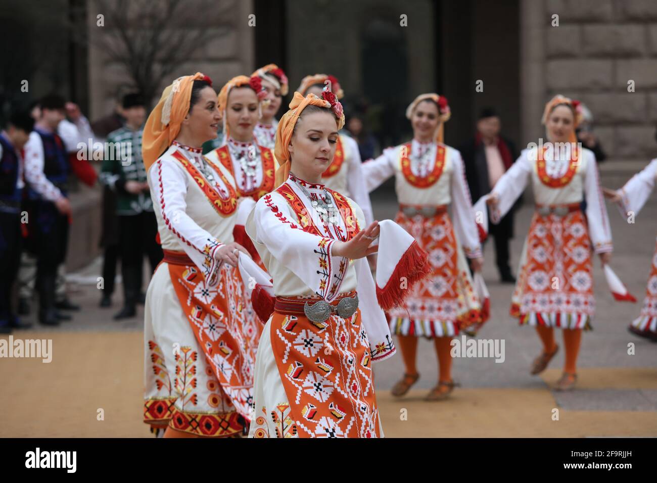 People in traditional folk costumes perform the Bulgarian folk dance ...