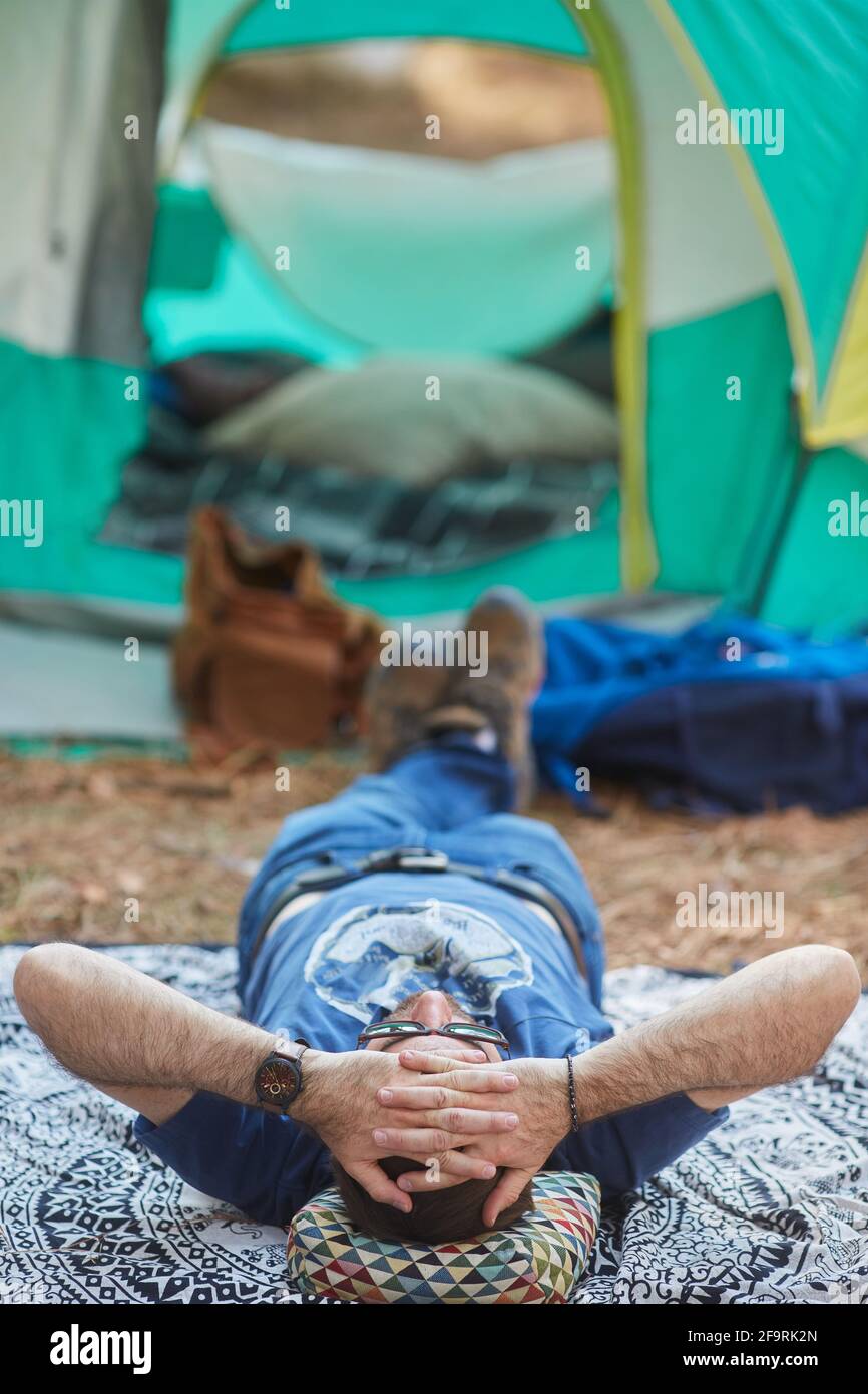 man resting lying outside his tent Stock Photo - Alamy