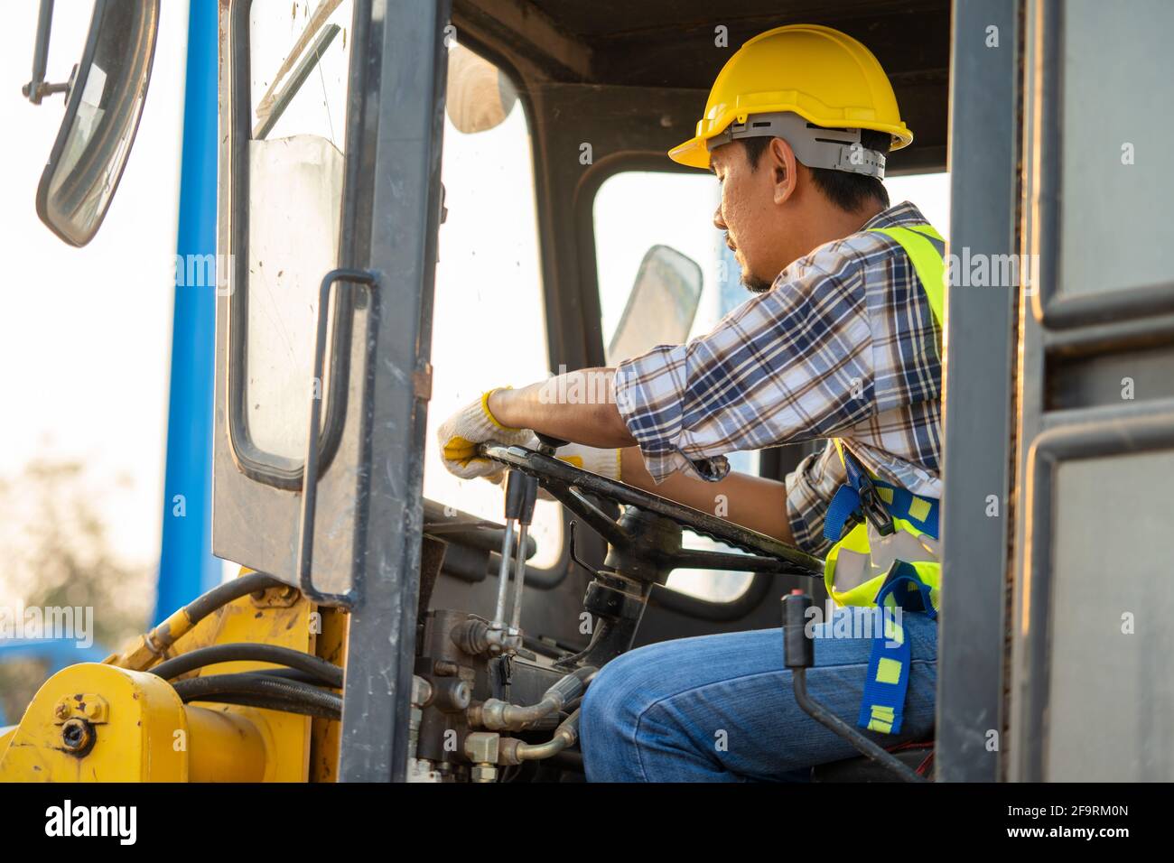 Worker driving industrial digger hi-res stock photography and images ...