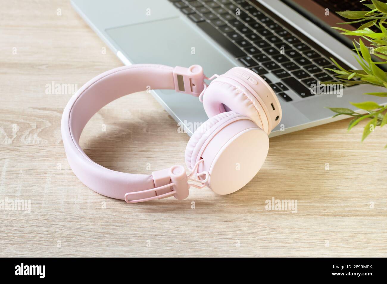 Laptop and headphone on wooden table. Working or studying desk. E ...