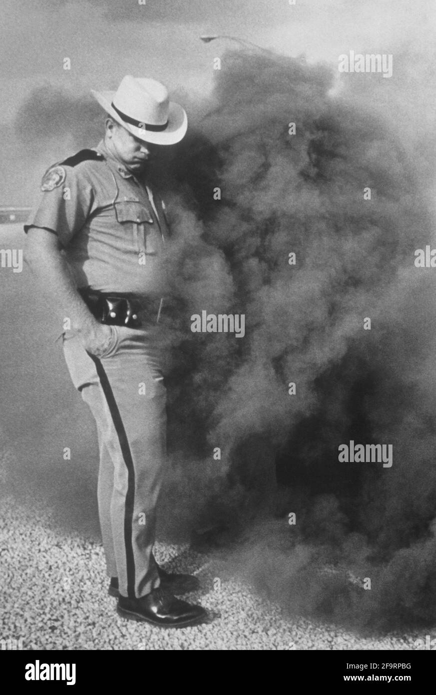 Highway Patrol trooper gets engulfed by smoke from a vehicle along a ...