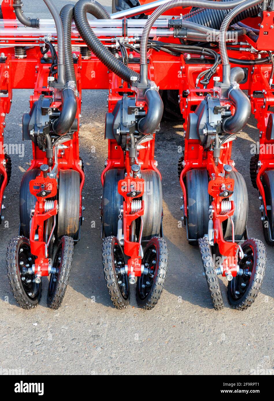 Fragment of a red modern pneumatic agricultural seeder, wheels ...