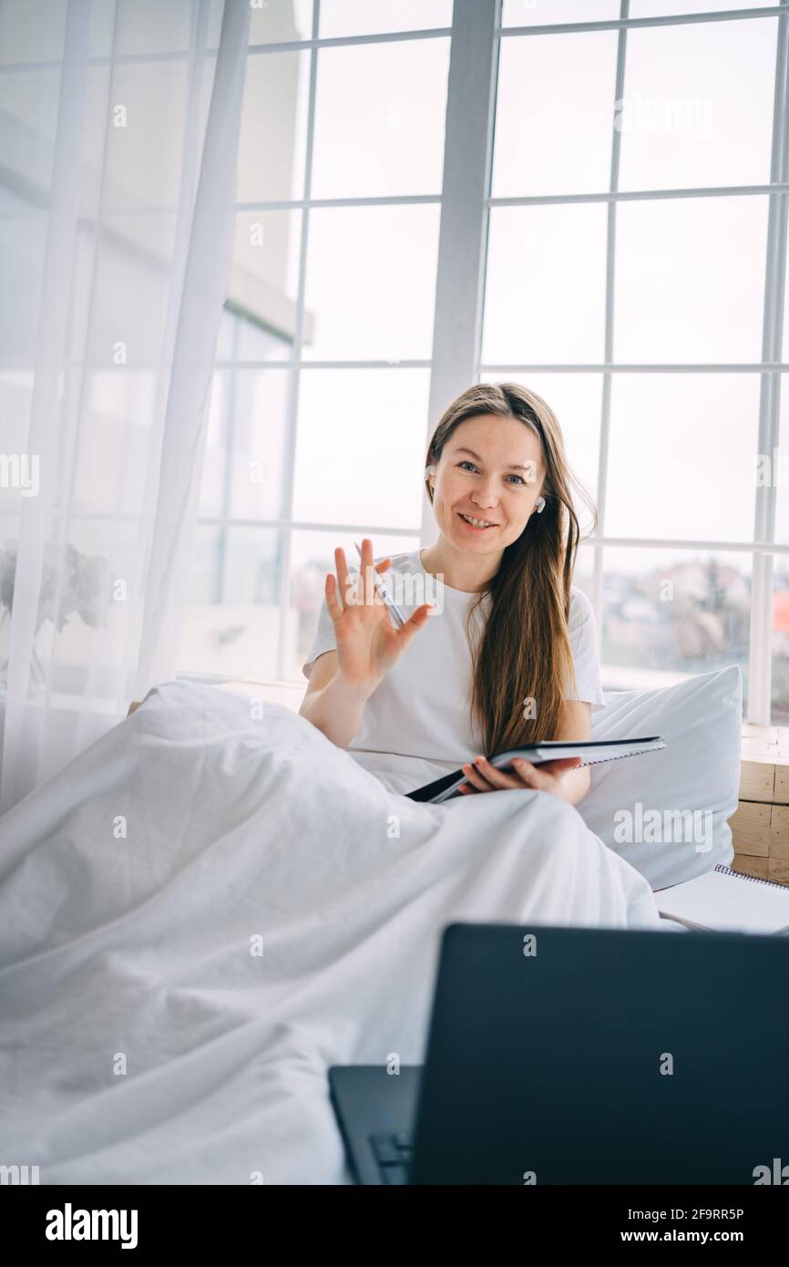 girl writes in a notebook and listens to music in bed Stock Photo - Alamy