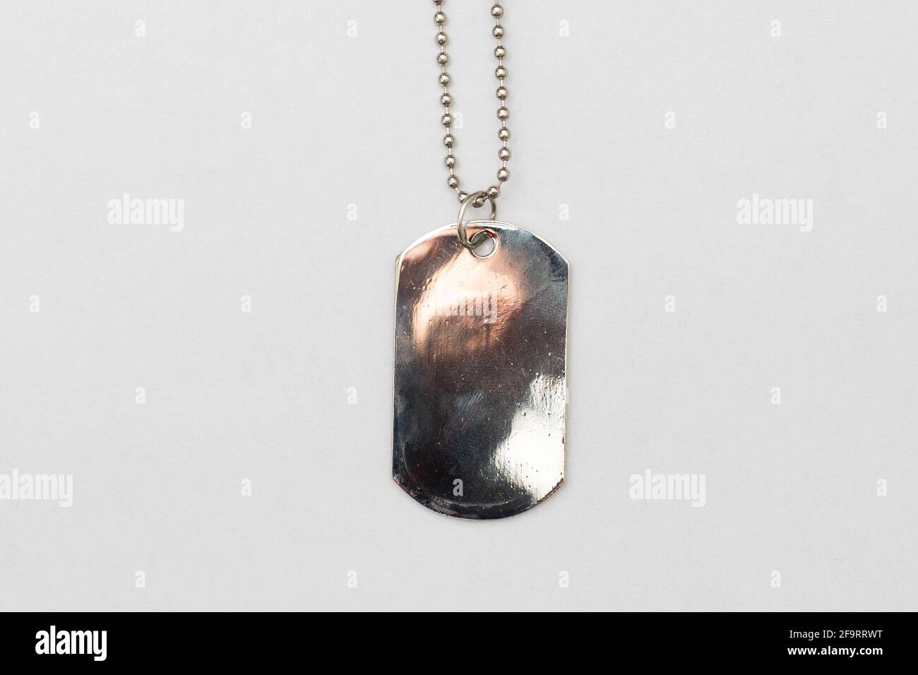 Identification badges on a chain, army badge Stock Photo - Alamy