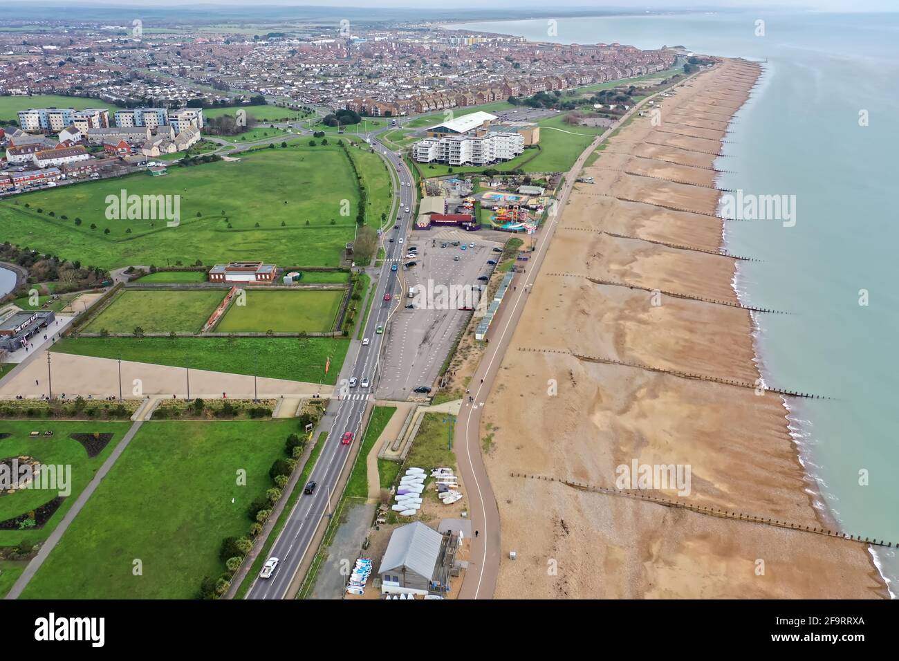 coastal beach aerial view of coast road, beach, sea and town over ...