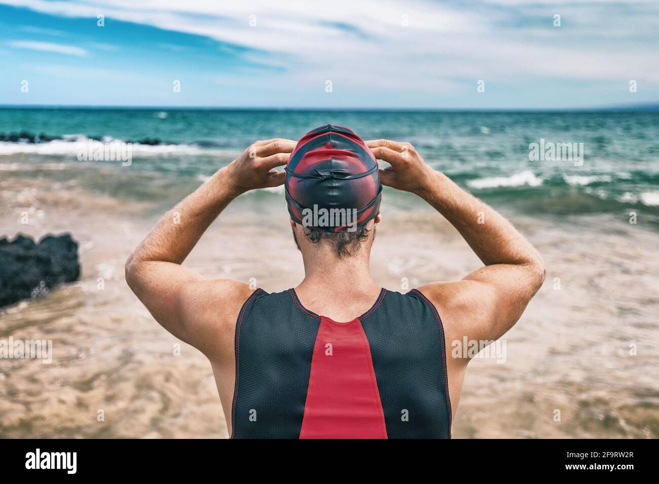 Triathlon swim sport man on race . Swimmer getting ready for open ocean ...