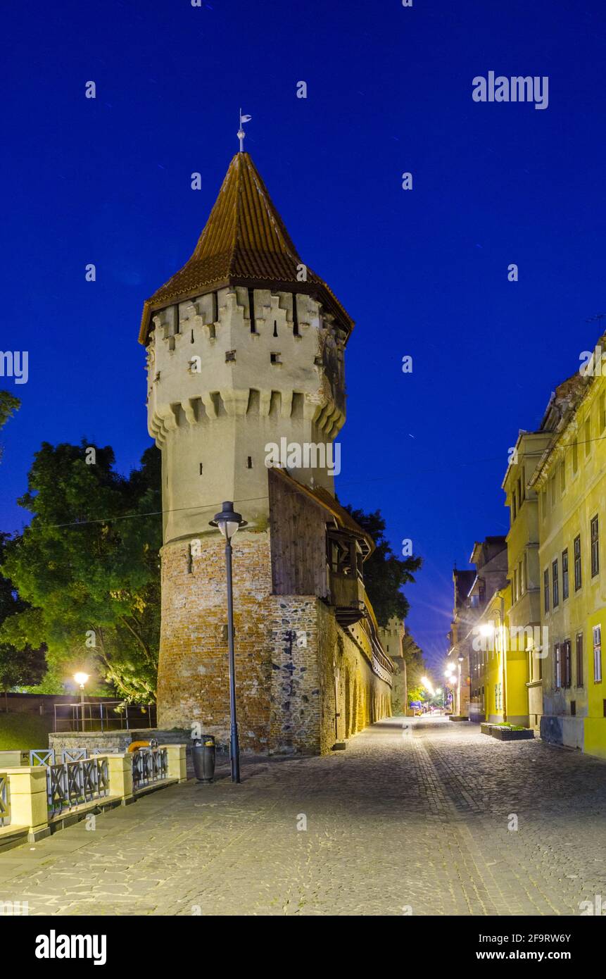 illuminated medieval defense wall and The Carpenters' Tower in Sibiu ...